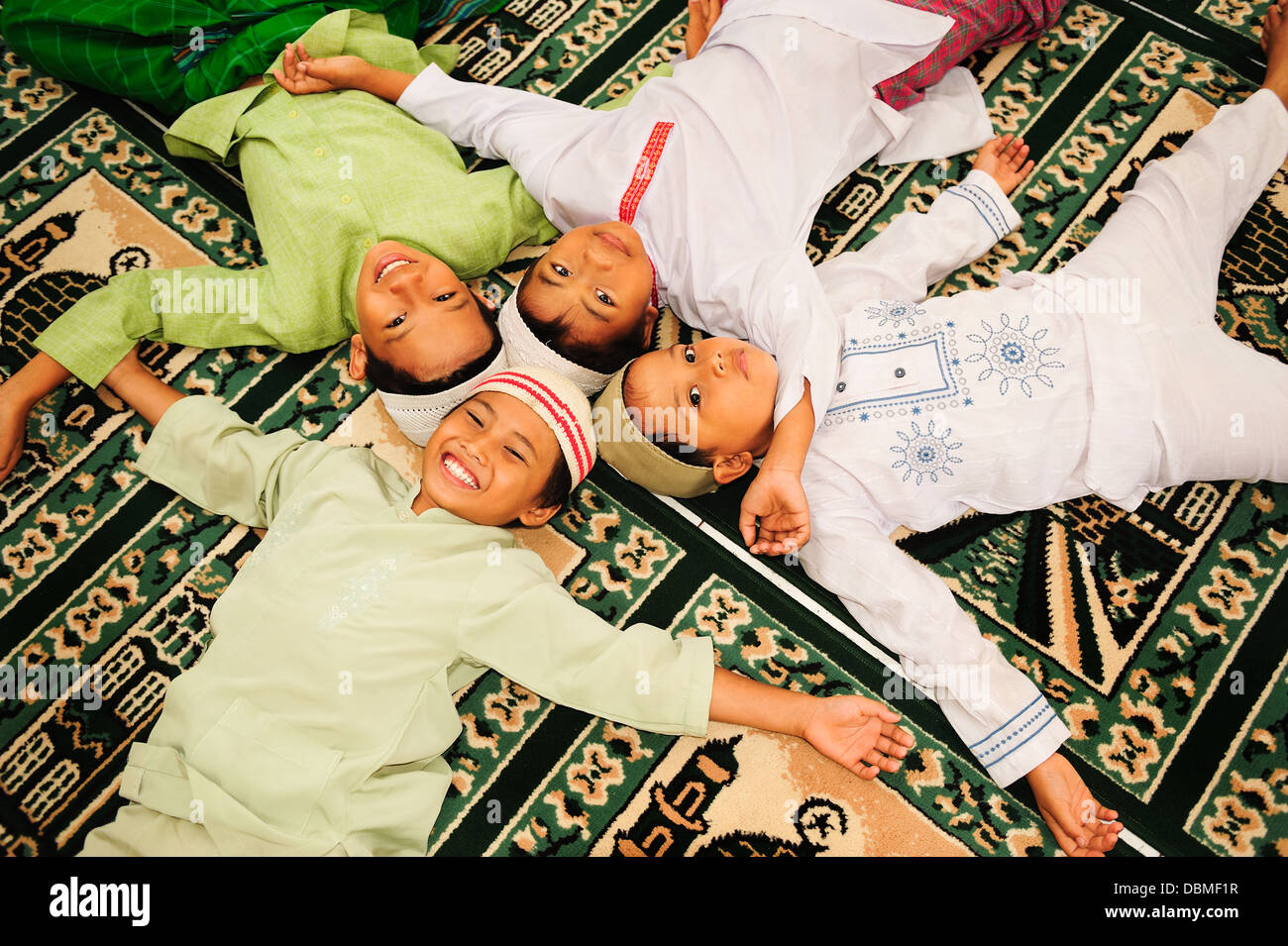 Muslim kids holding hands in a Mosque Stock Photo - Alamy