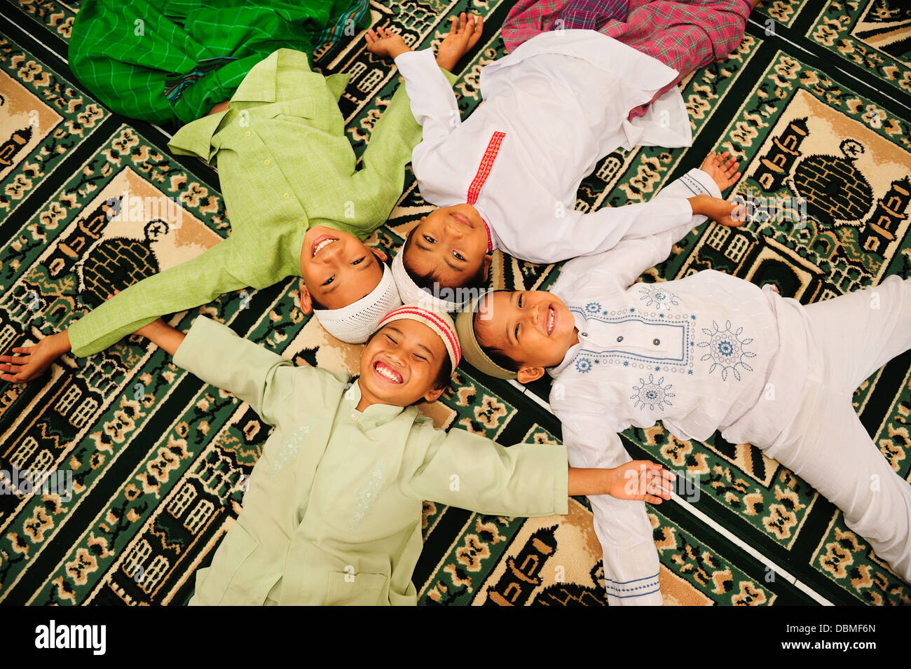 Muslim kids holding hands in a Mosque Stock Photo - Alamy
