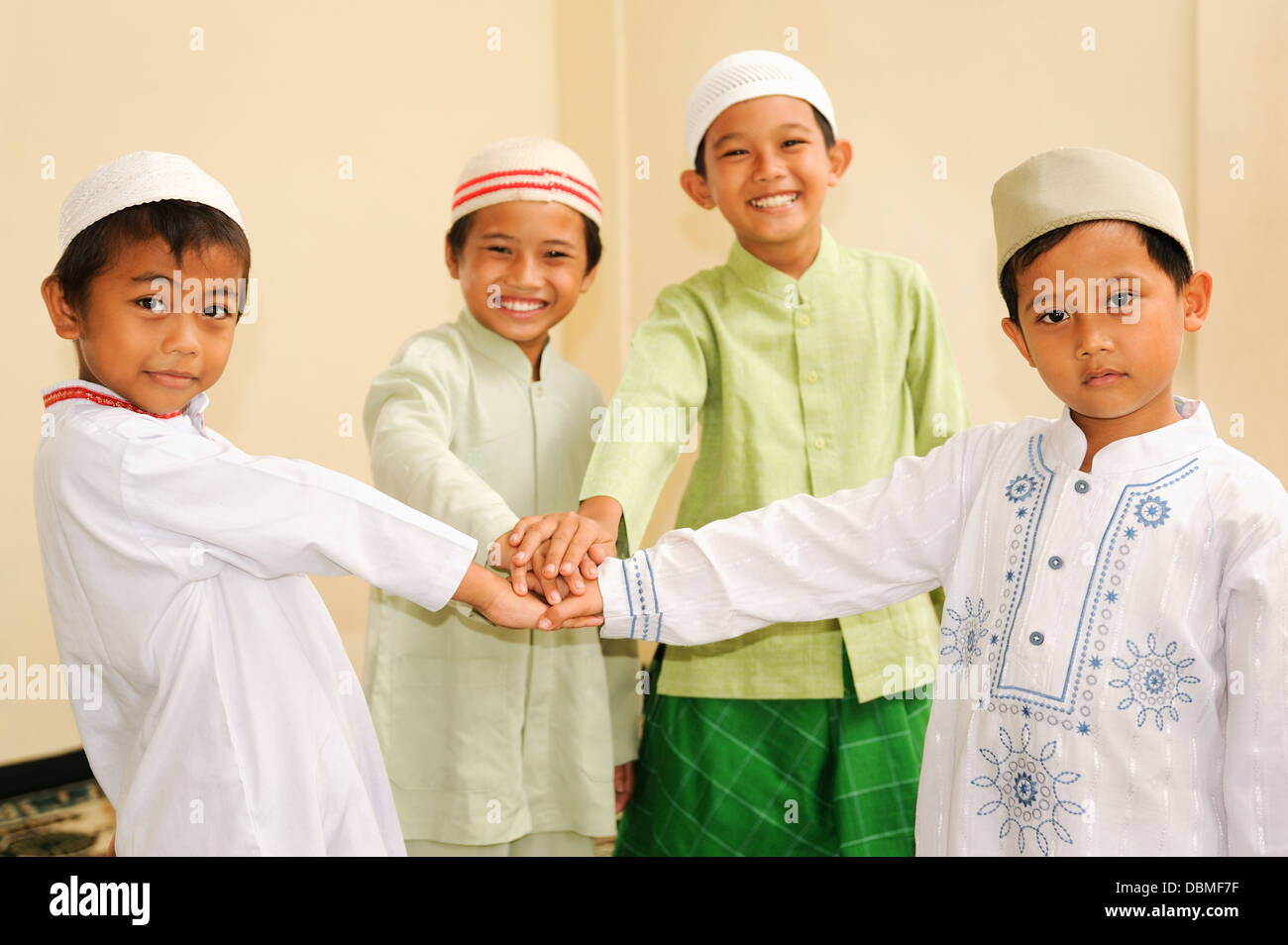 Muslim kids holding hands in a Mosque Stock Photo - Alamy