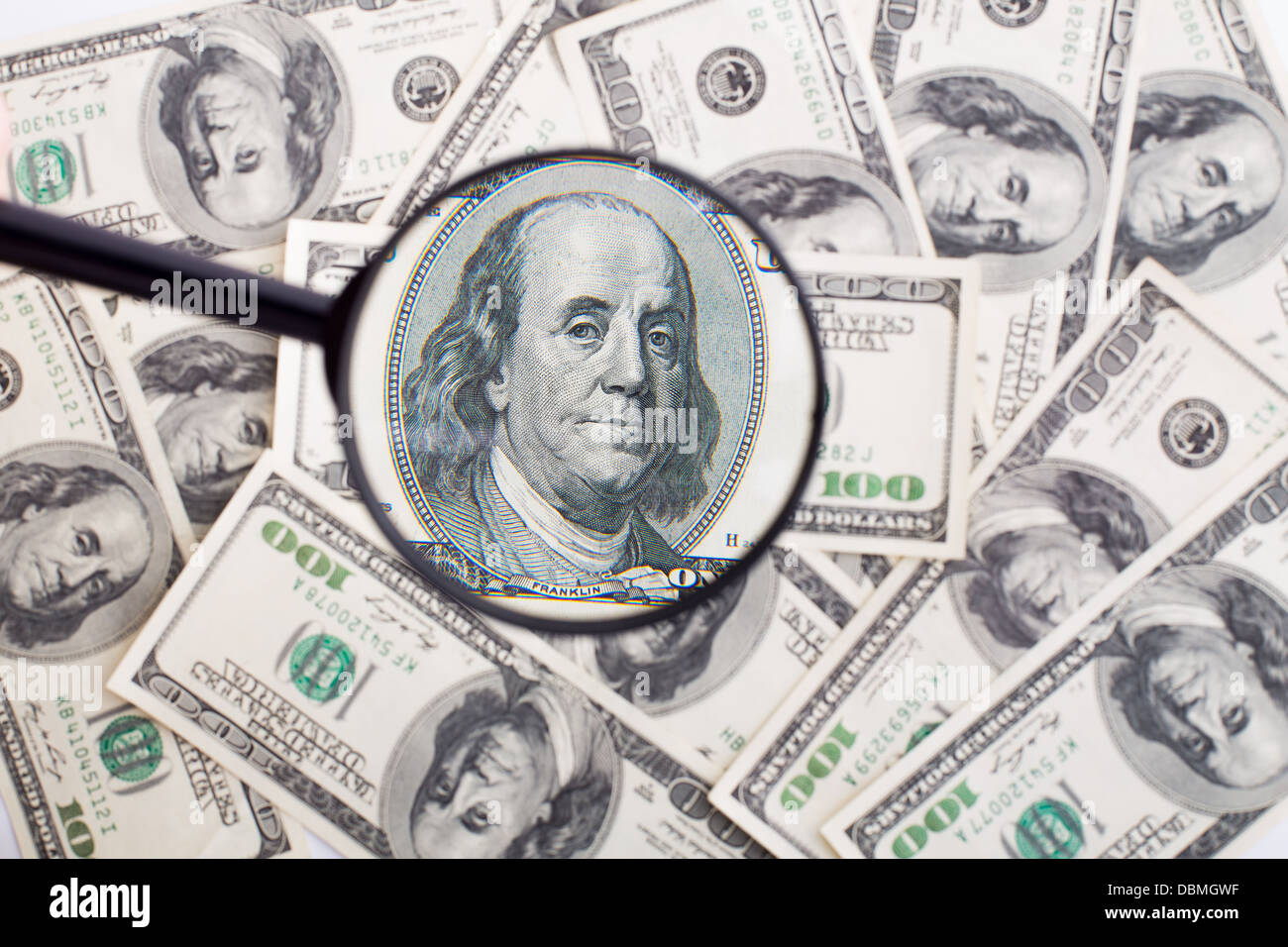 Dollars and black magnifying glass Stock Photo - Alamy