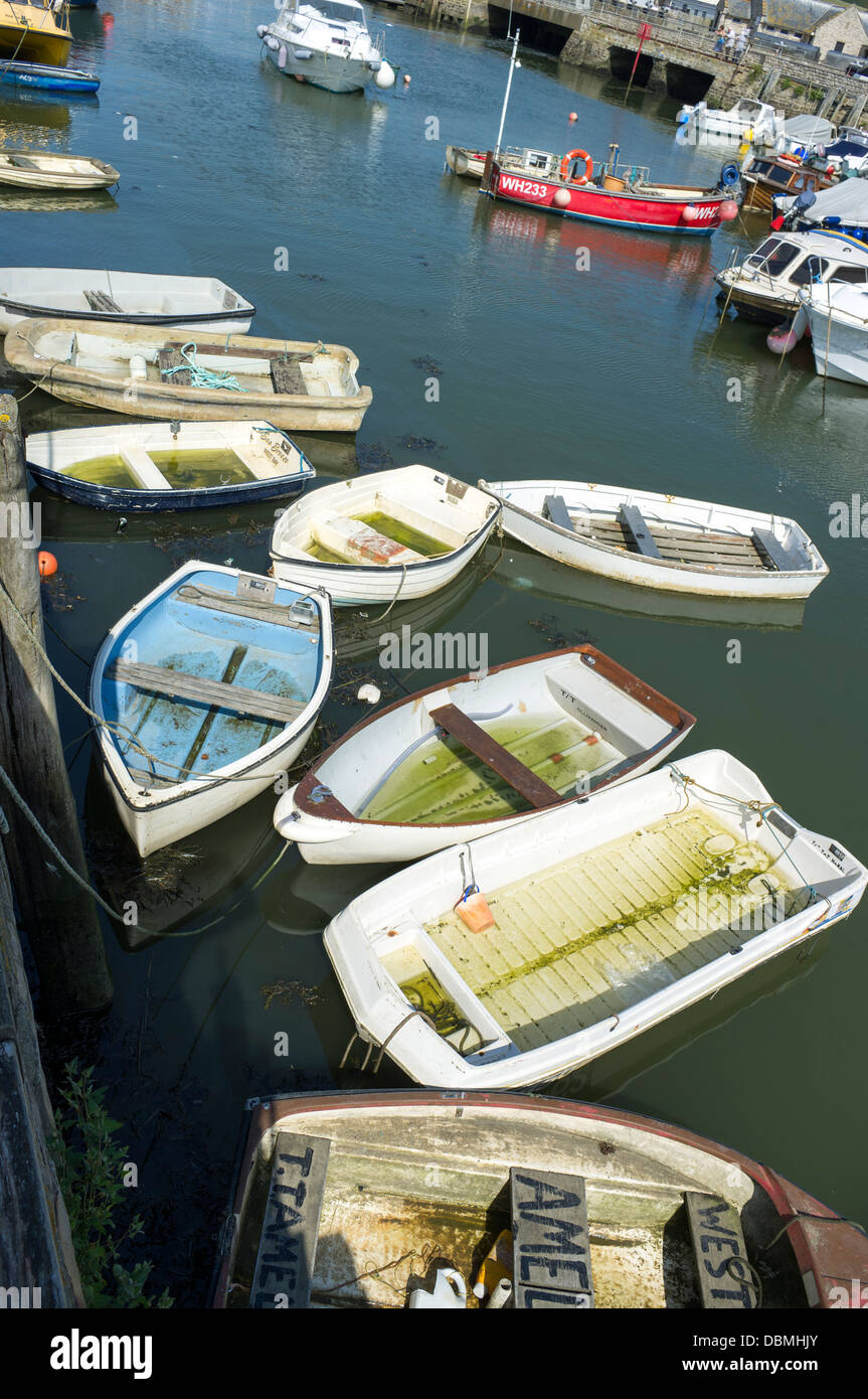 Collection of rowing boats moored in West Bay Harbour Dorset UK Stock ...
