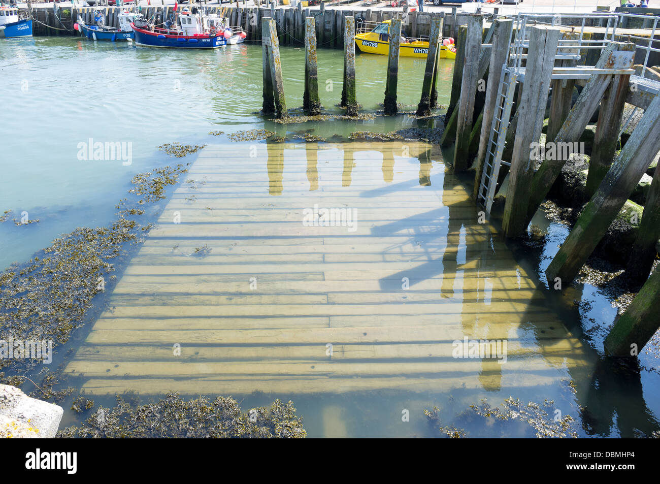 Sunken wooden platform timber structure beneath water in West Bay ...