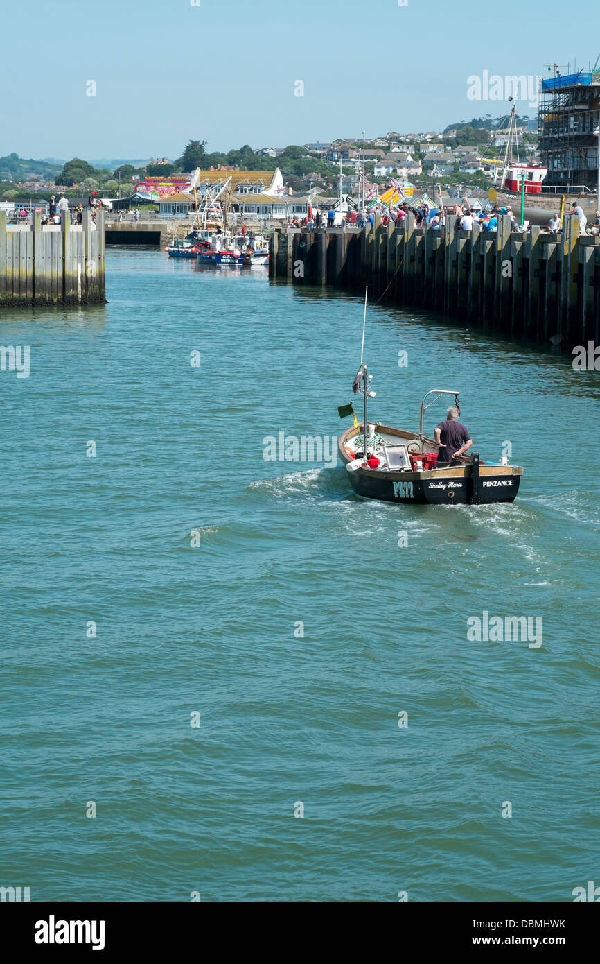 Small fishing boat returning to West Bay Harbour in Dorset UK Stock ...