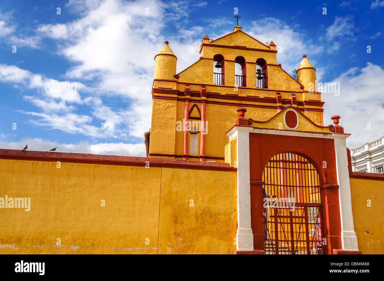 Yellow and red colonial style church in the town of San Cristobal de ...