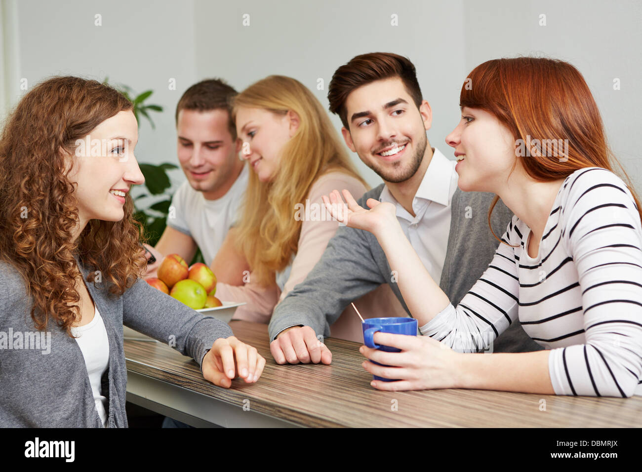 Happy students taking a coffee break in break room Stock Photo - Alamy