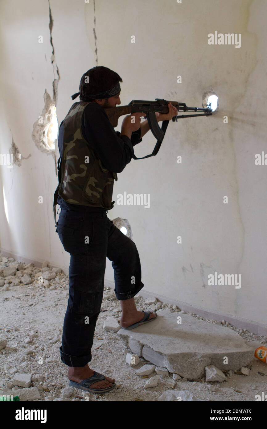 Aleppo, Syria: A Free Syrian Army member takes aim at a regime position ...