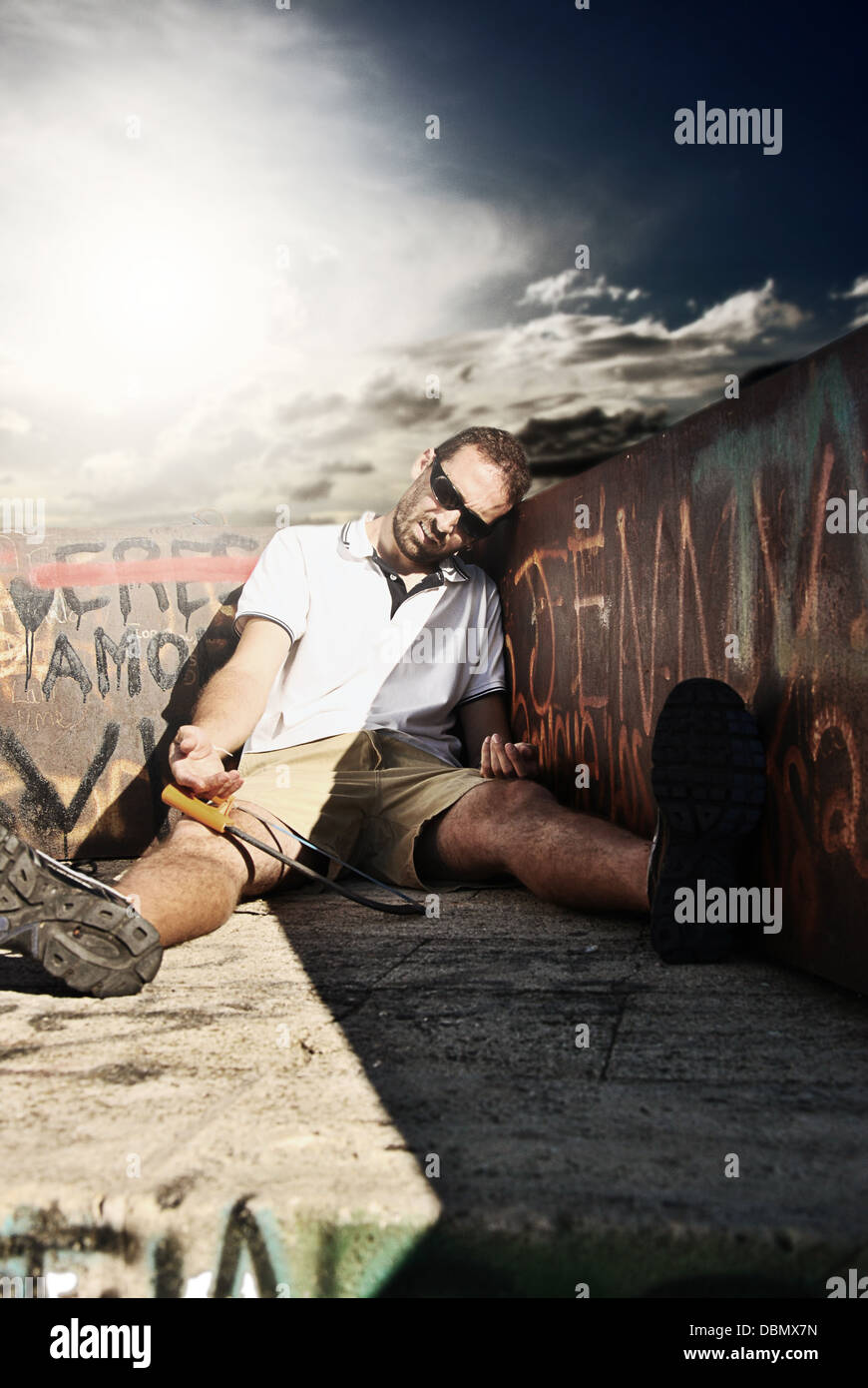 failed worker lying on the ground half drunk Stock Photo - Alamy