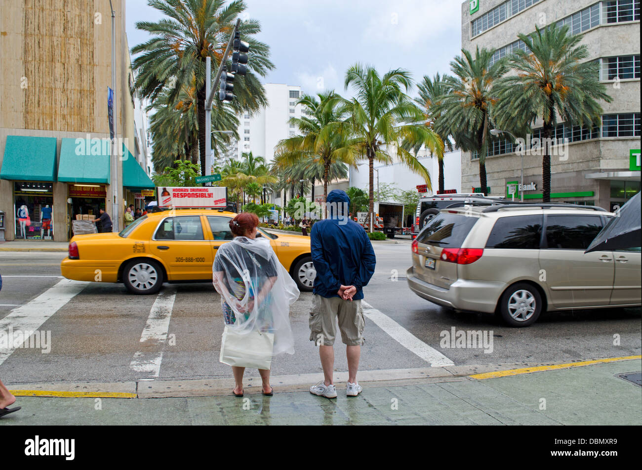 Two visitors to South Beach Miami, dressed for the rainy day on their ...