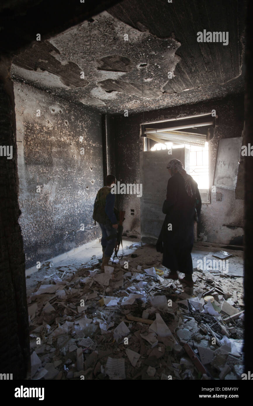 Free Syrian army members walk through the Salhin Police station during ...