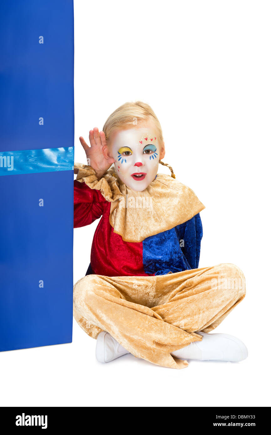 Curious little clown girl listening into a secret surprise box Stock ...