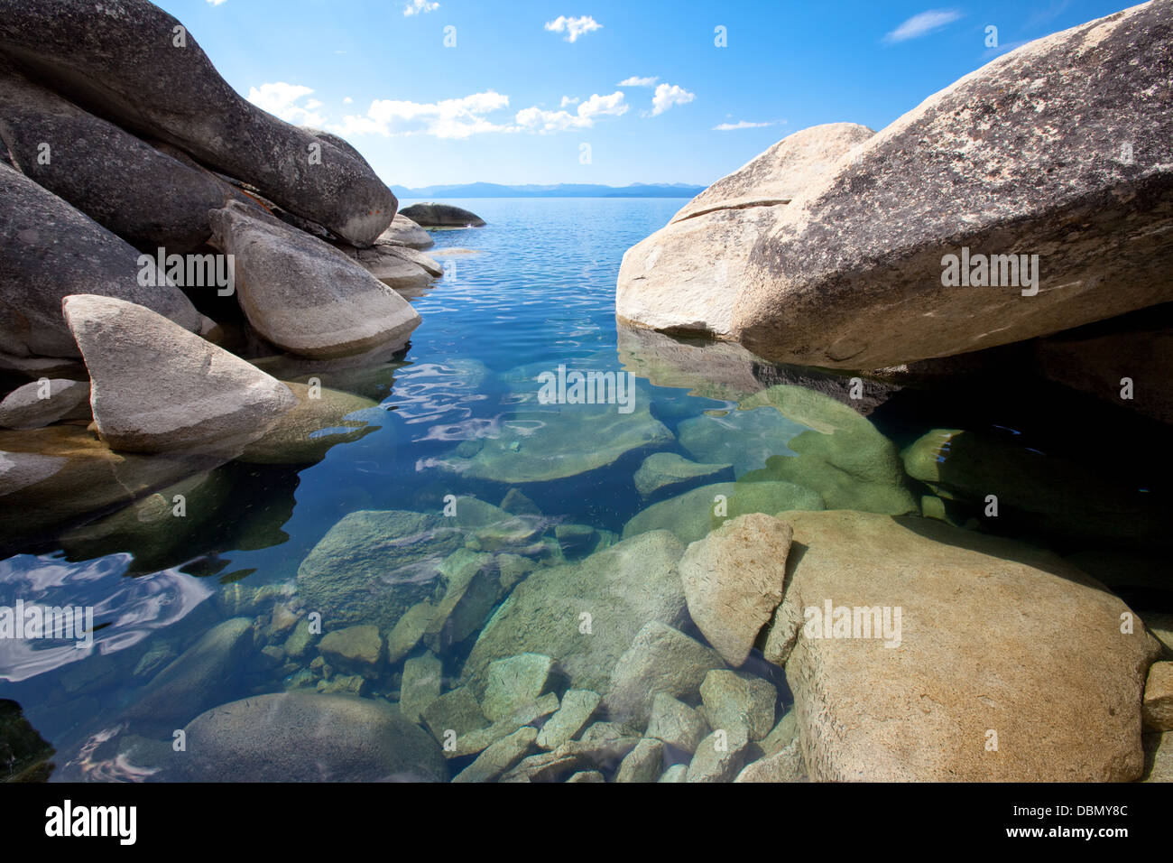 Large, smooth granite boulders define a beautiful shoreline of pristine ...