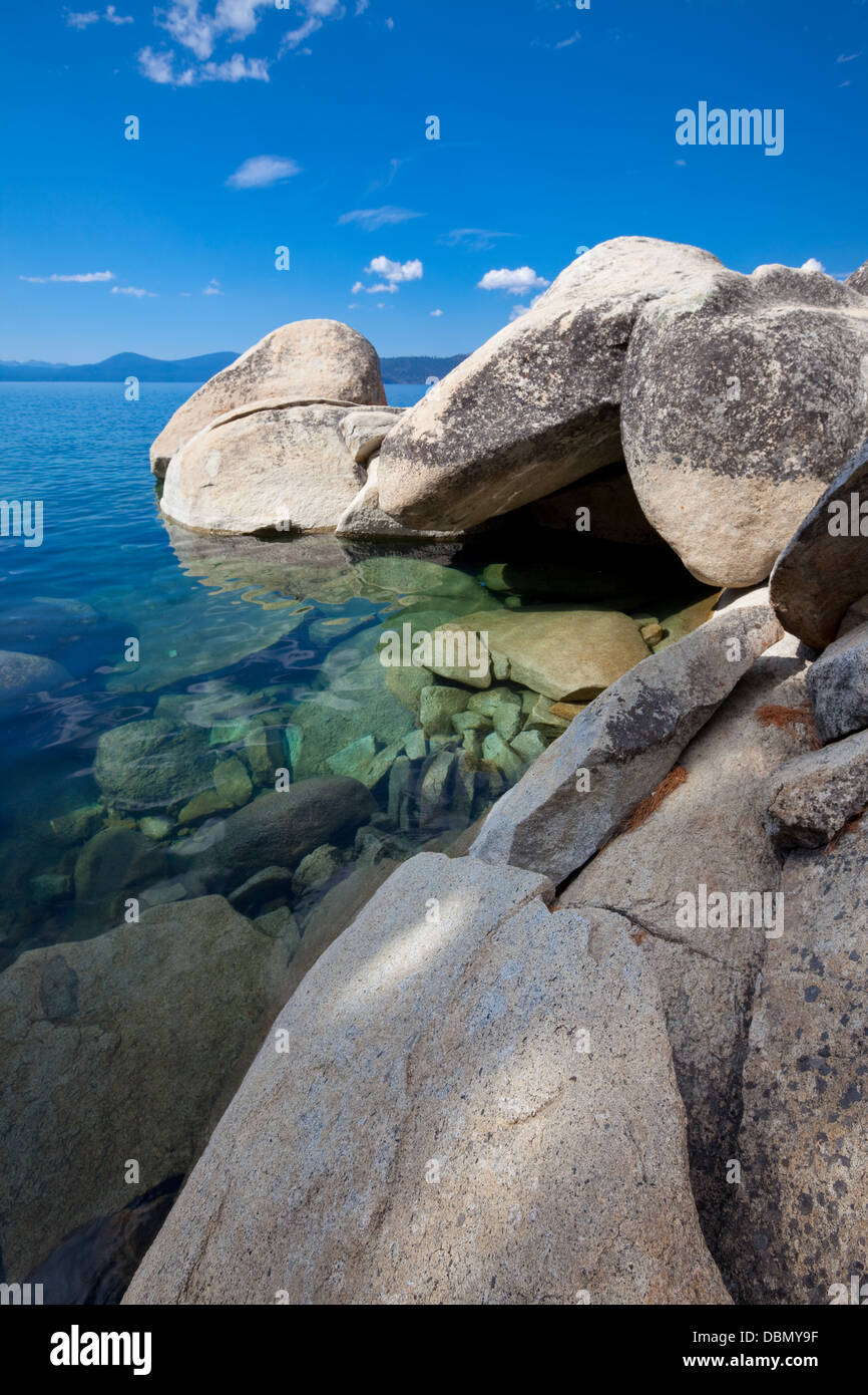 Large, smooth granite boulders define a beautiful shoreline of pristine ...