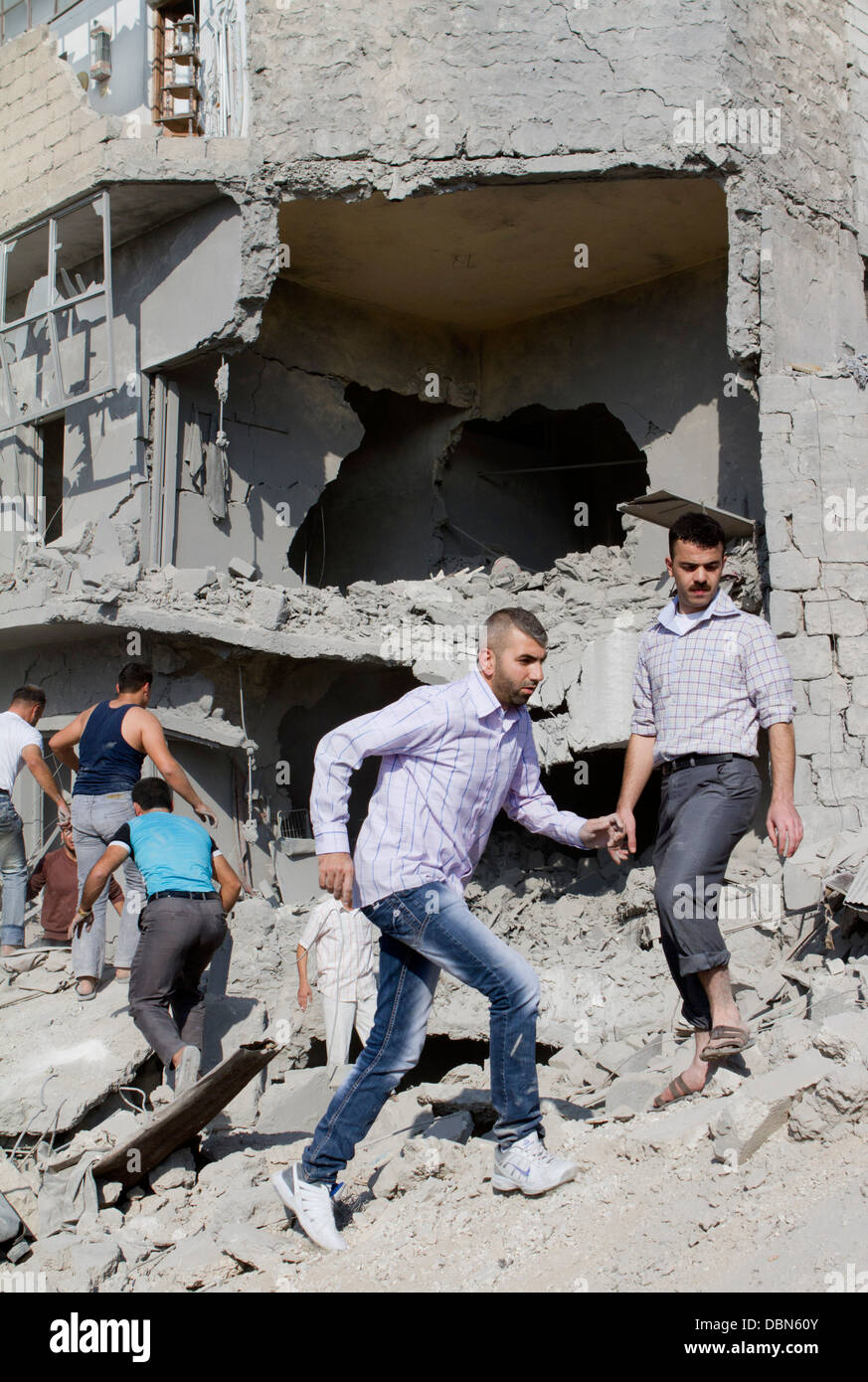 People scramble to free people from the rubble after a MIG bombing of ...