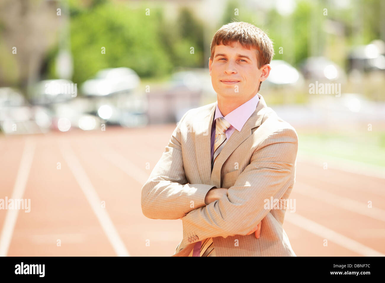 Businessman at athletic stadium and race track Stock Photo - Alamy