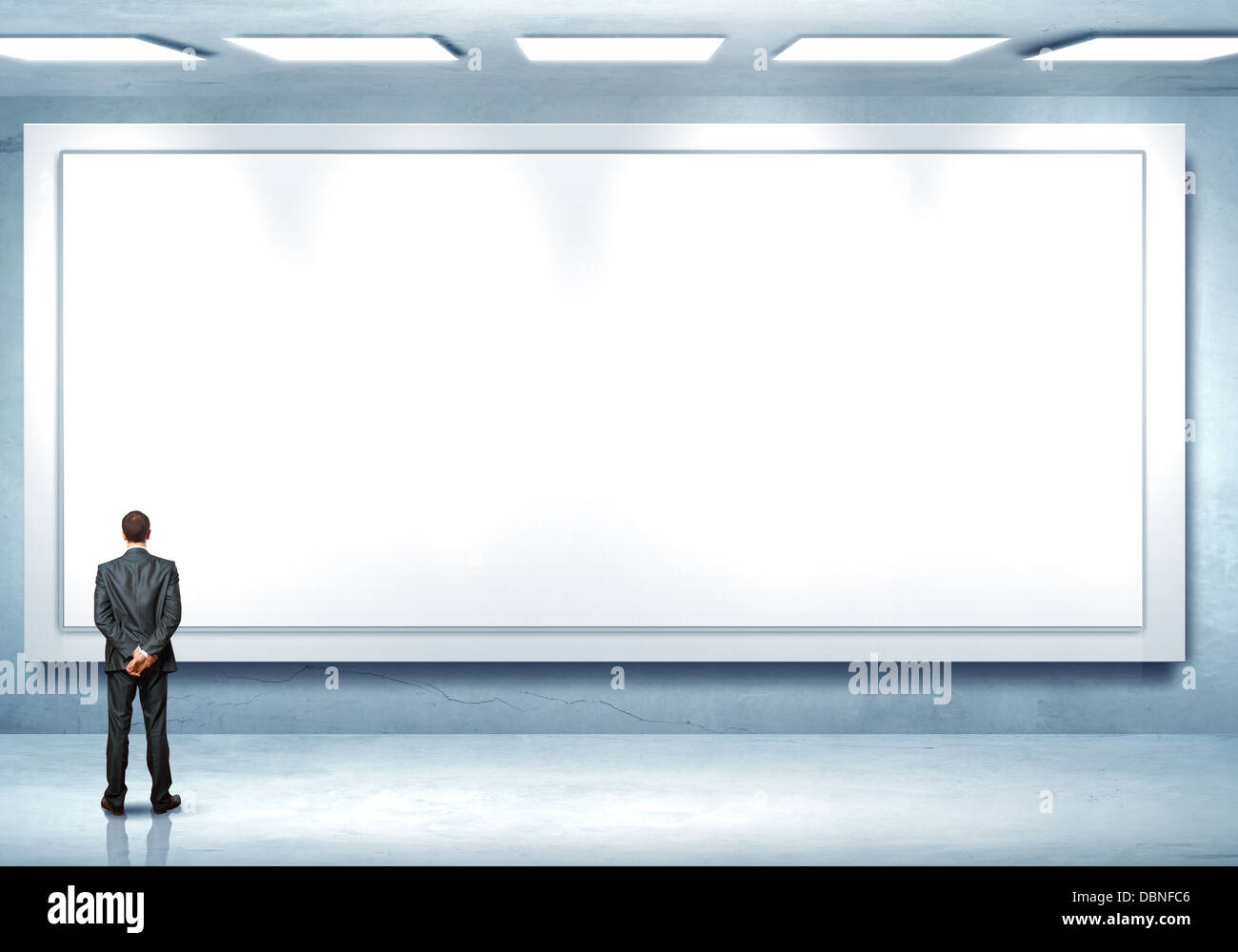 Business person standing near a blank billboard Stock Photo - Alamy