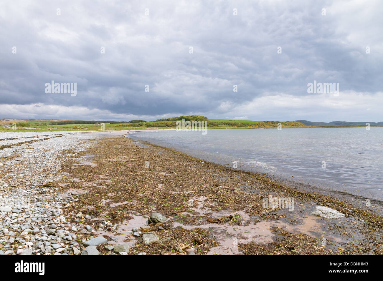 A wide view of the Scalpsie Bay beach, Isle of Bute, under an angry ...