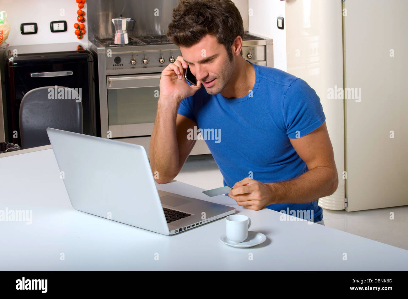 man in the kitchen with laptop Stock Photo - Alamy
