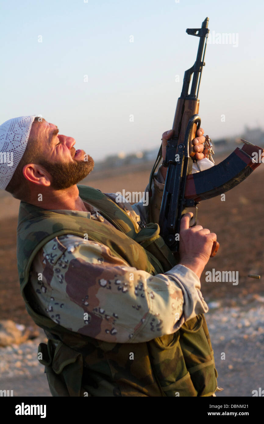 A Free Syrian Army rebel fires his AK-47 into the air in Aleppo, Syria ...