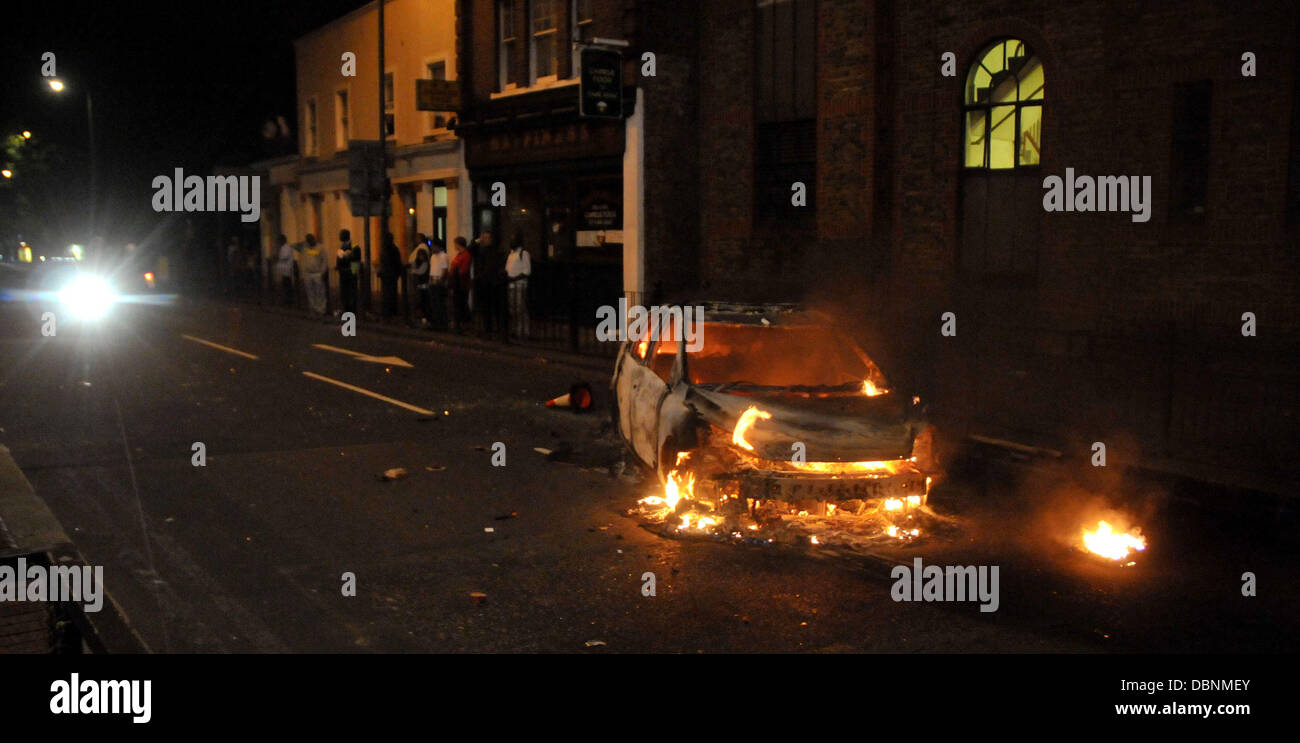 Pictured: A burned out police car Rioters in Tottenham, North London ...