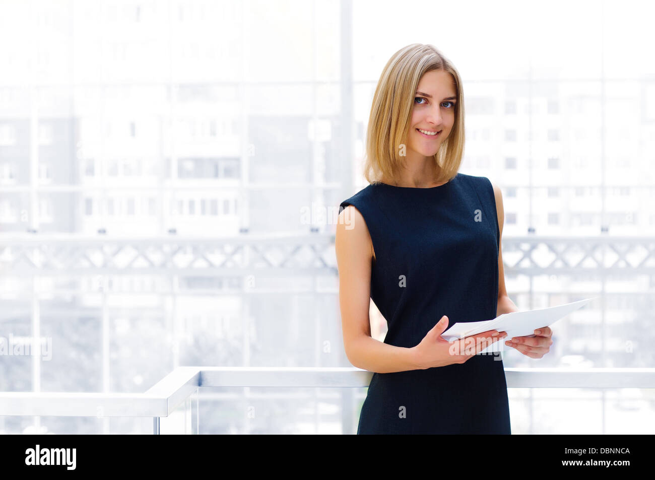 business woman holding reports and looking to the camera Stock Photo ...