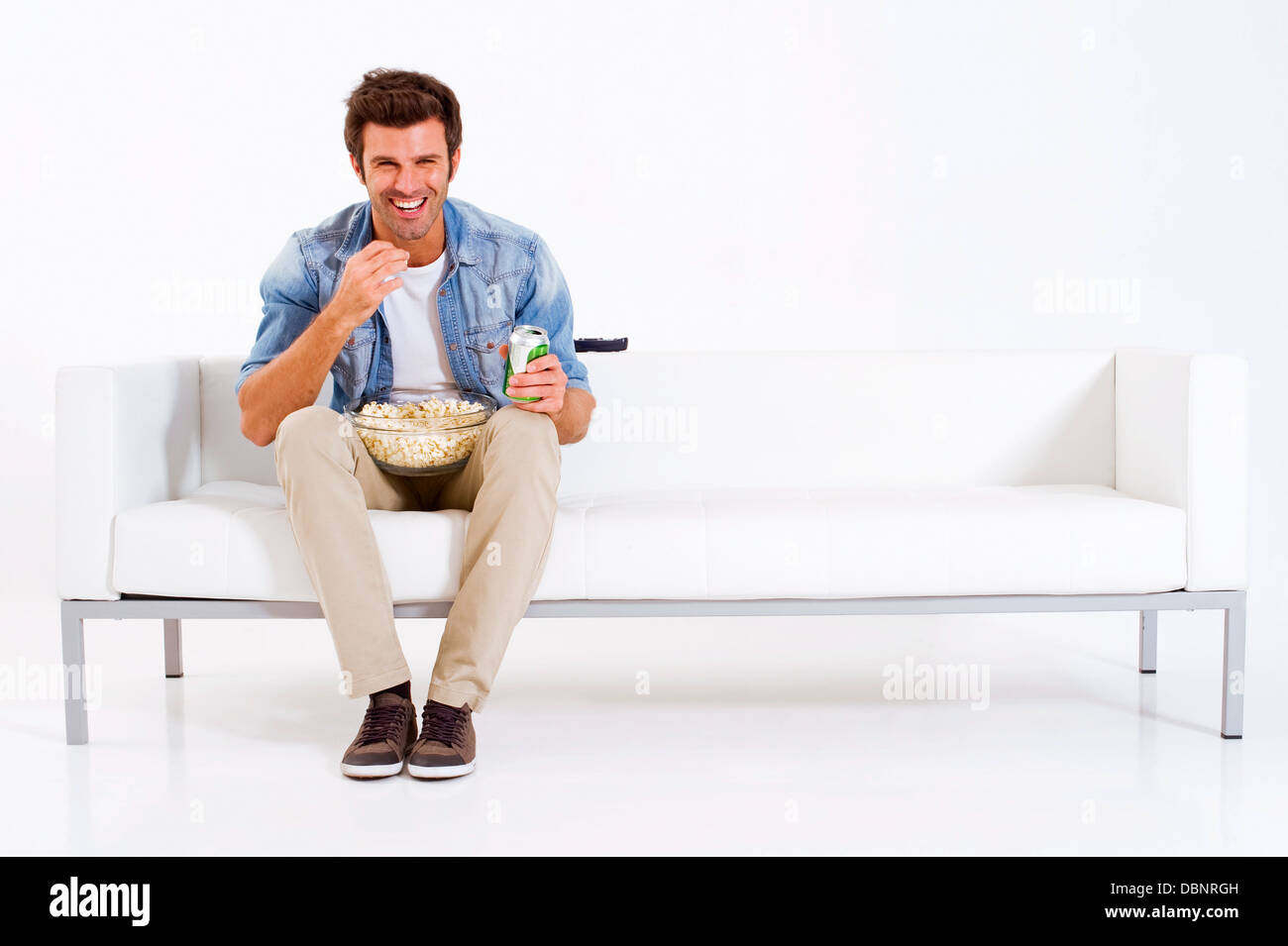single man on the couch watching TV Stock Photo - Alamy
