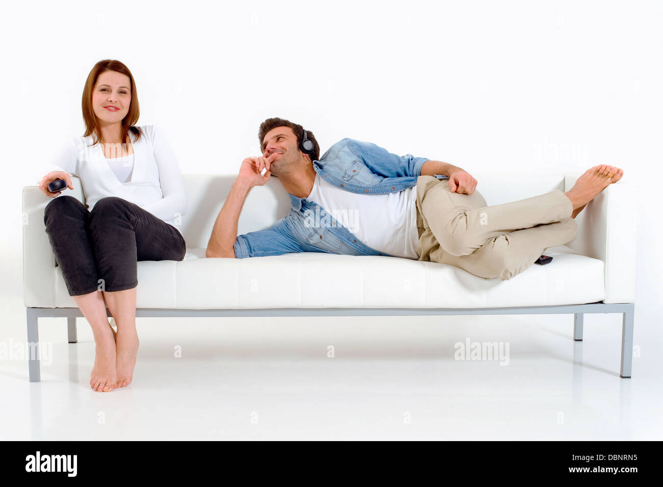 separated couple on the couch watching TV Stock Photo - Alamy