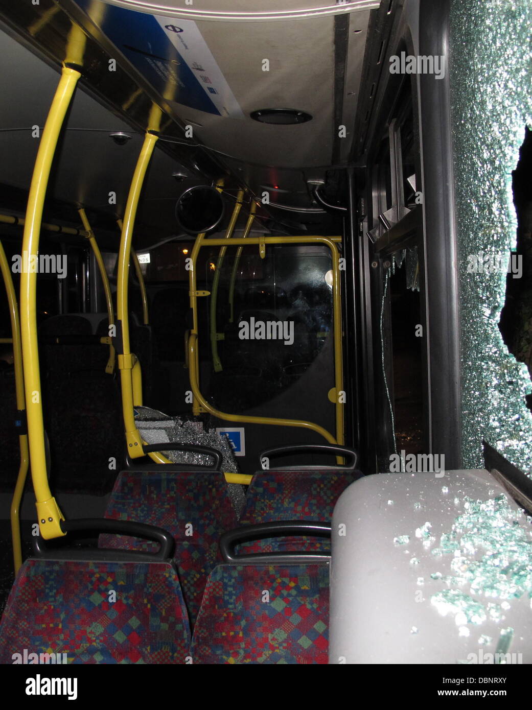 A bus with broken windows, which was taken over by rioters in Ealing ...