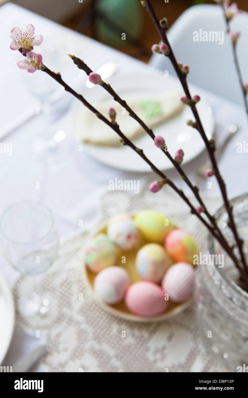 Easter breakfast, set table with painted eggs and cherry blossom ...