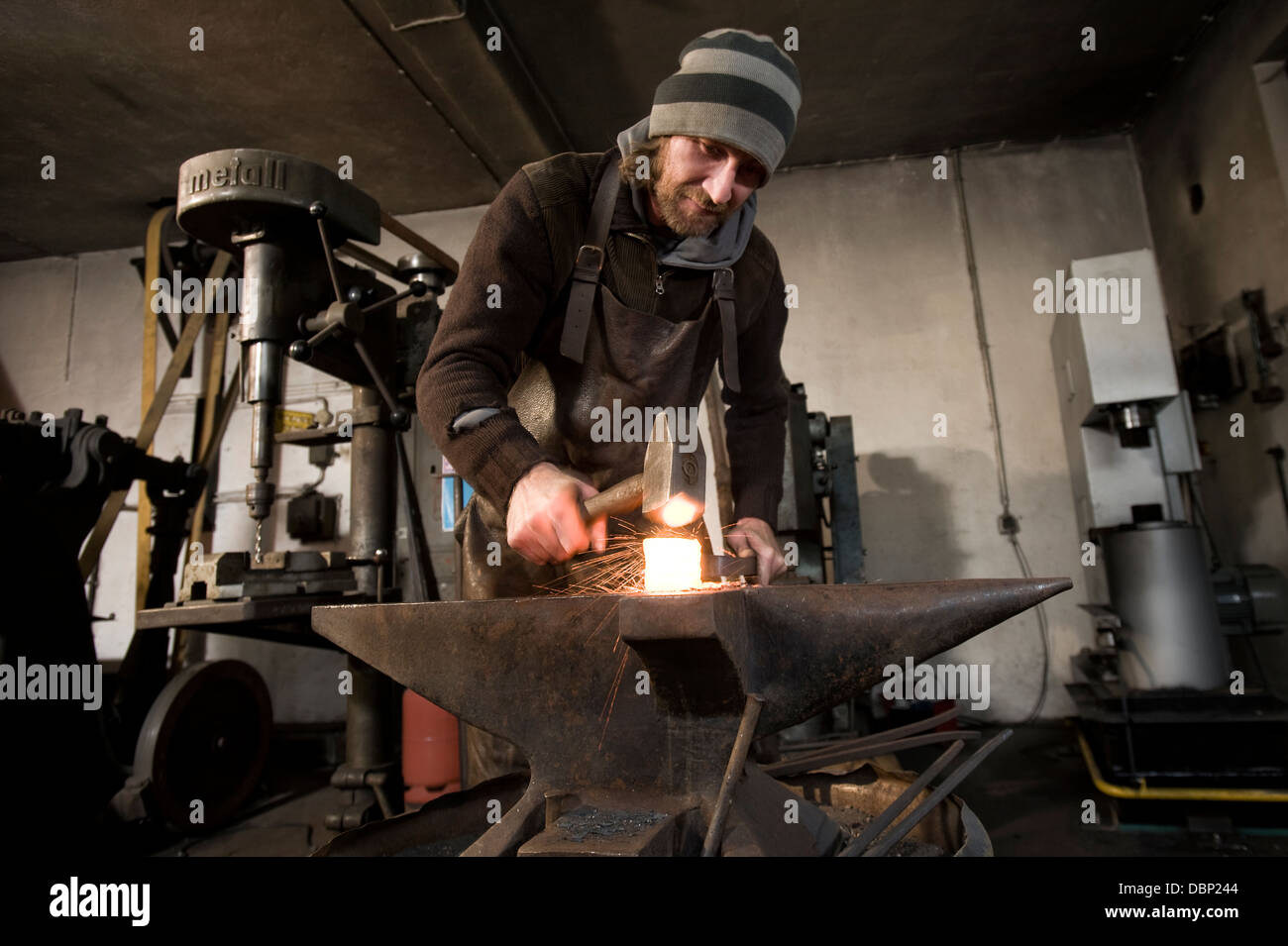 Blacksmith hammering metal on an anvil, Landshut, Bavaria, Germany ...