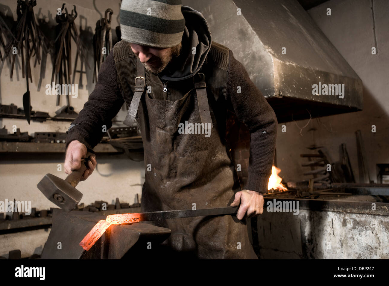 Blacksmith hammering metal on an anvil, Landshut, Bavaria, Germany ...