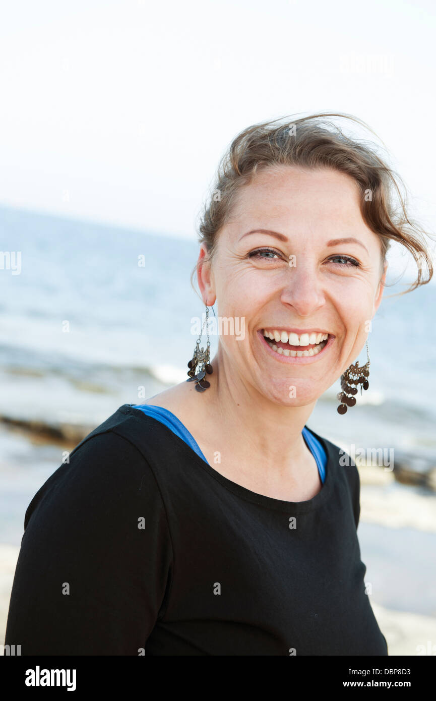 Portrait of woman, sea in background Stock Photo - Alamy