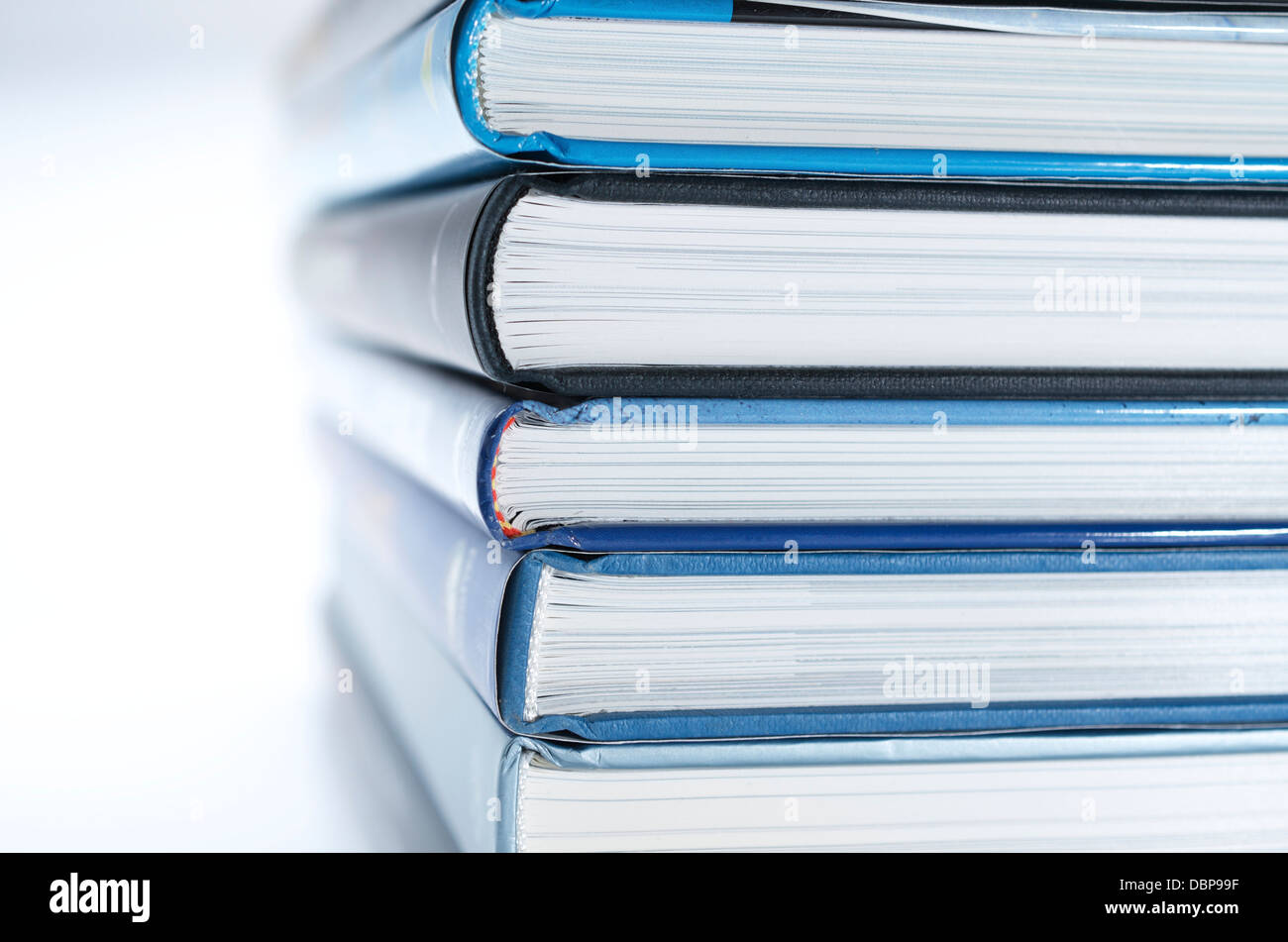forefront of a group of books stacked Stock Photo - Alamy