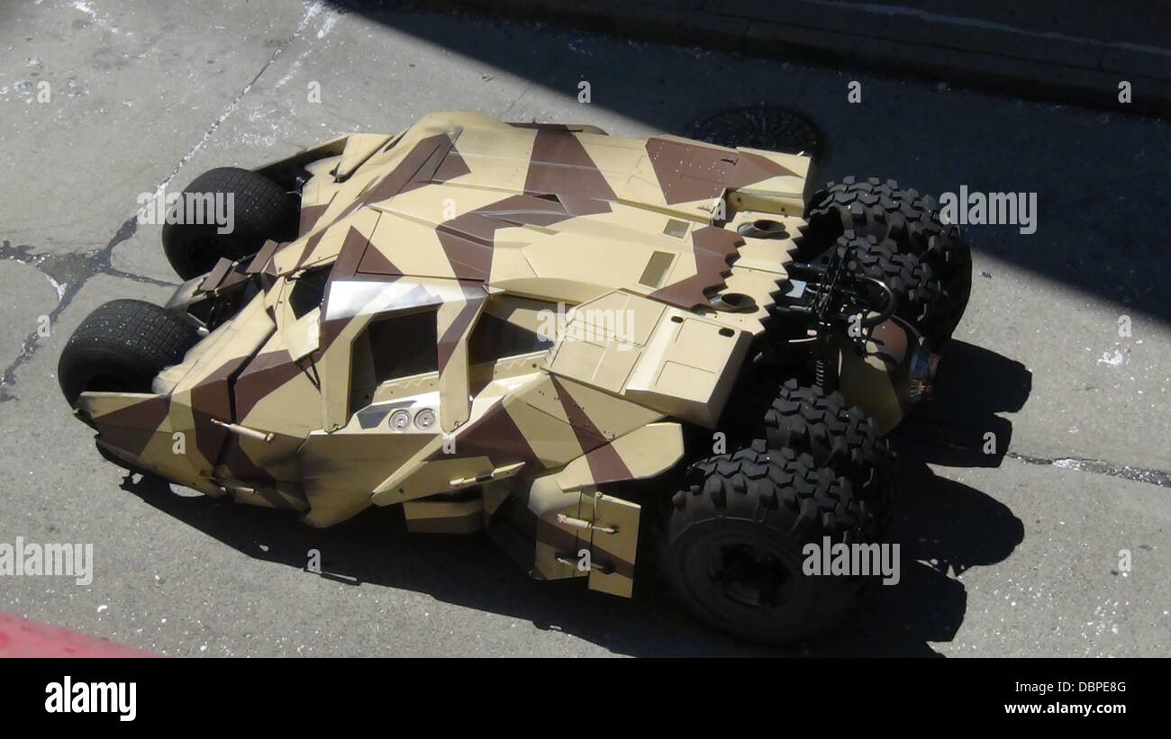 The Batplane is transported through a scene with a Batman figure in the ...