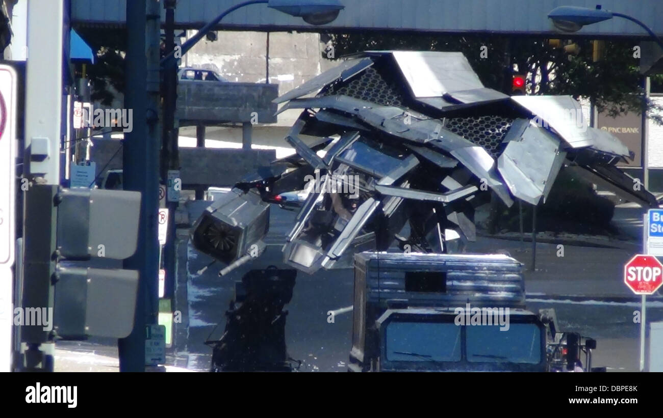 The Batplane is transported through a scene with a Batman figure in the ...