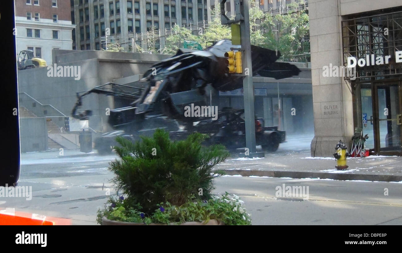 The Batplane is transported through a scene with a Batman figure in the ...