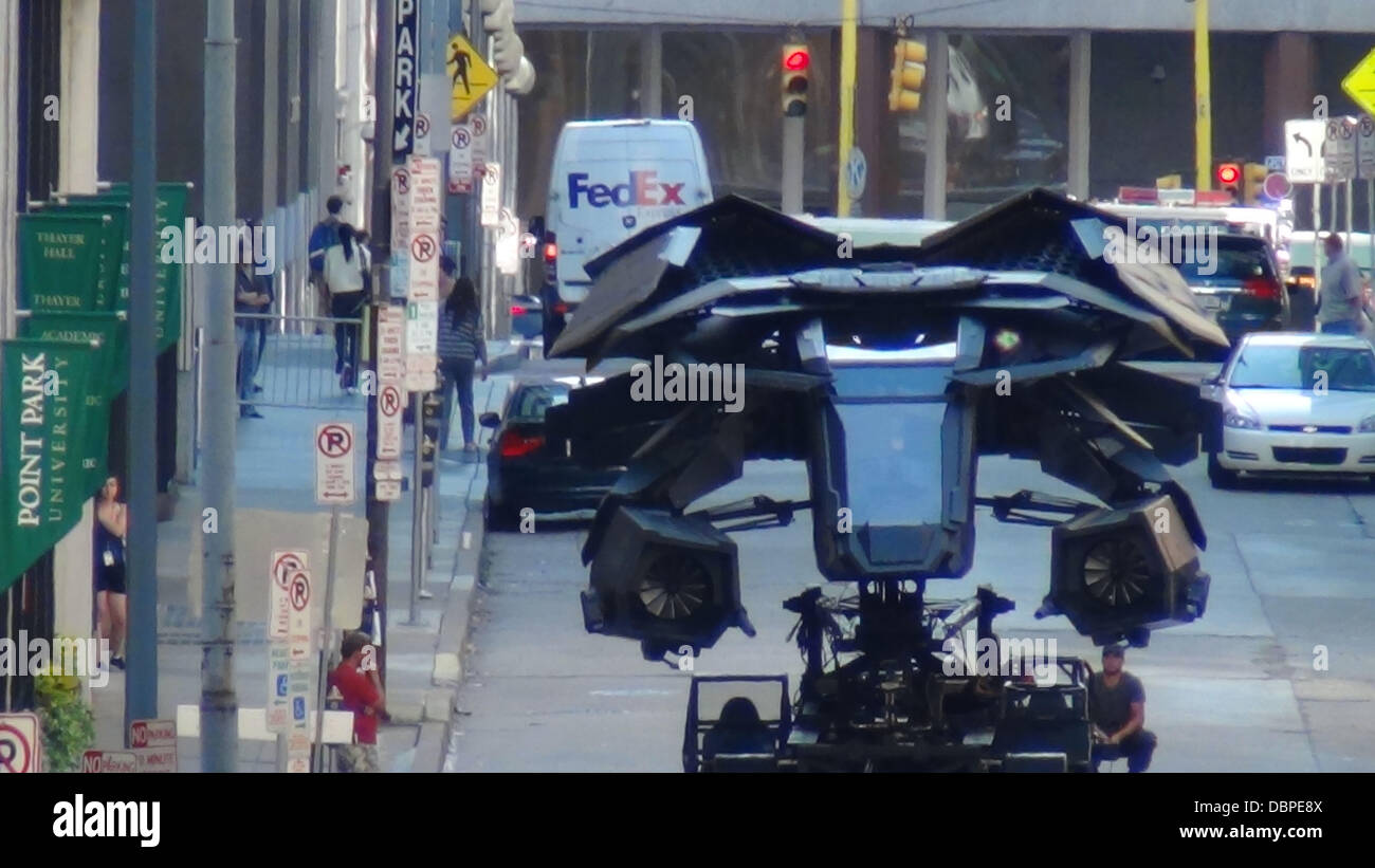 The Batplane is transported through a scene with a Batman figure in the ...