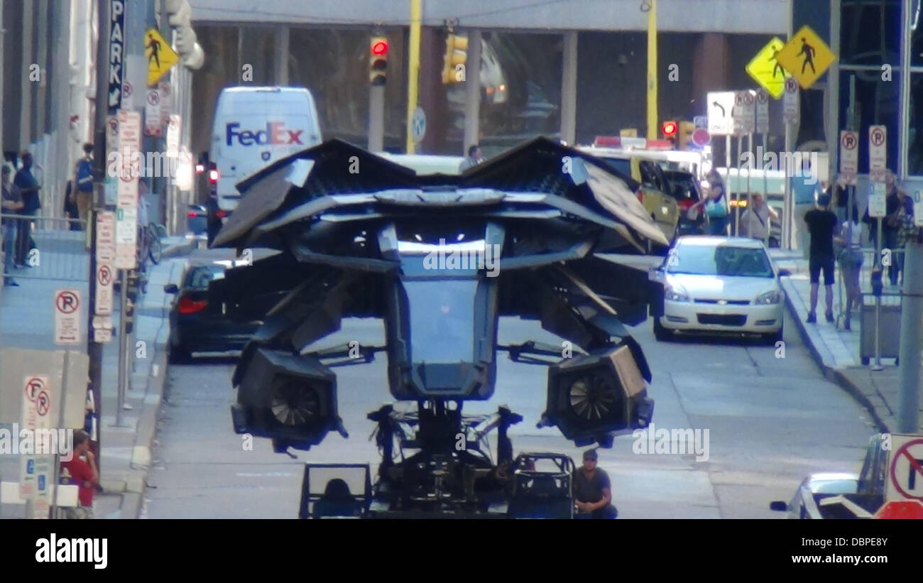 The Batplane is transported through a scene with a Batman figure in the ...