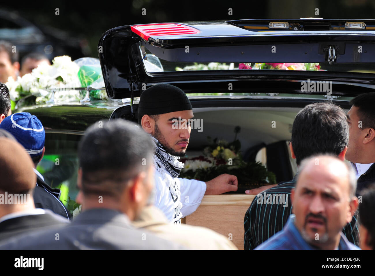 Atmosphere Family and friends are comforted by the hearses during the ...