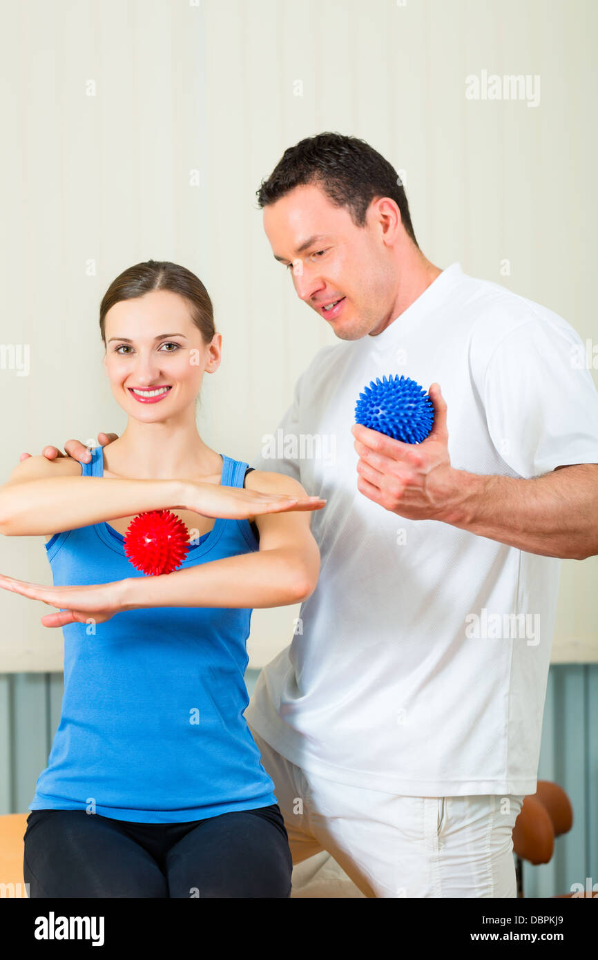Female Patient at the physiotherapy doing physical exercises with her therapist, they using a ...