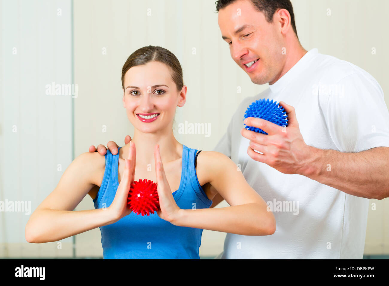 Female Patient at the physiotherapy doing physical exercises with her ...