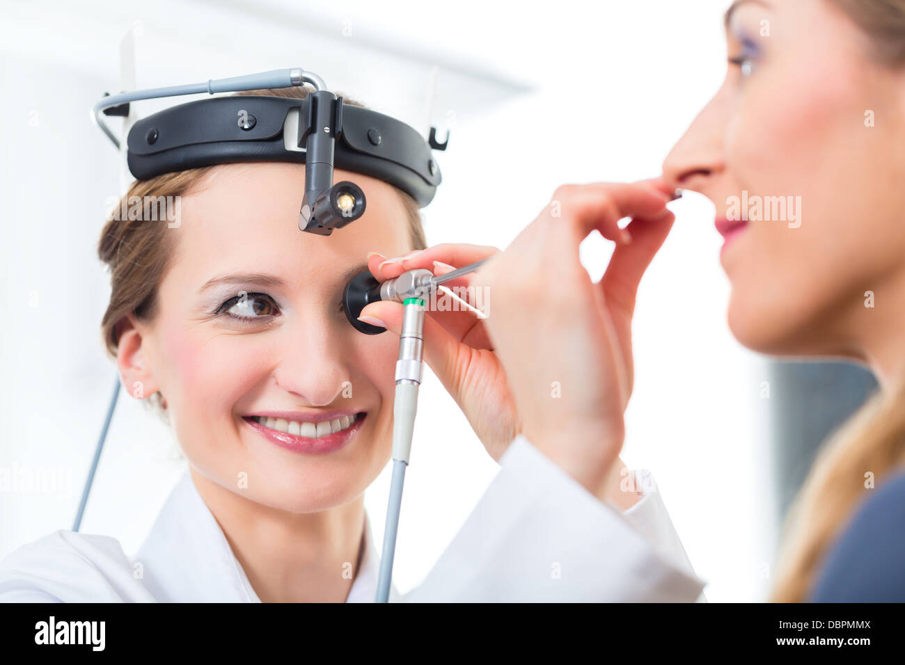 Doctor - Young female consultant or ENT specialist - with a patient in ...