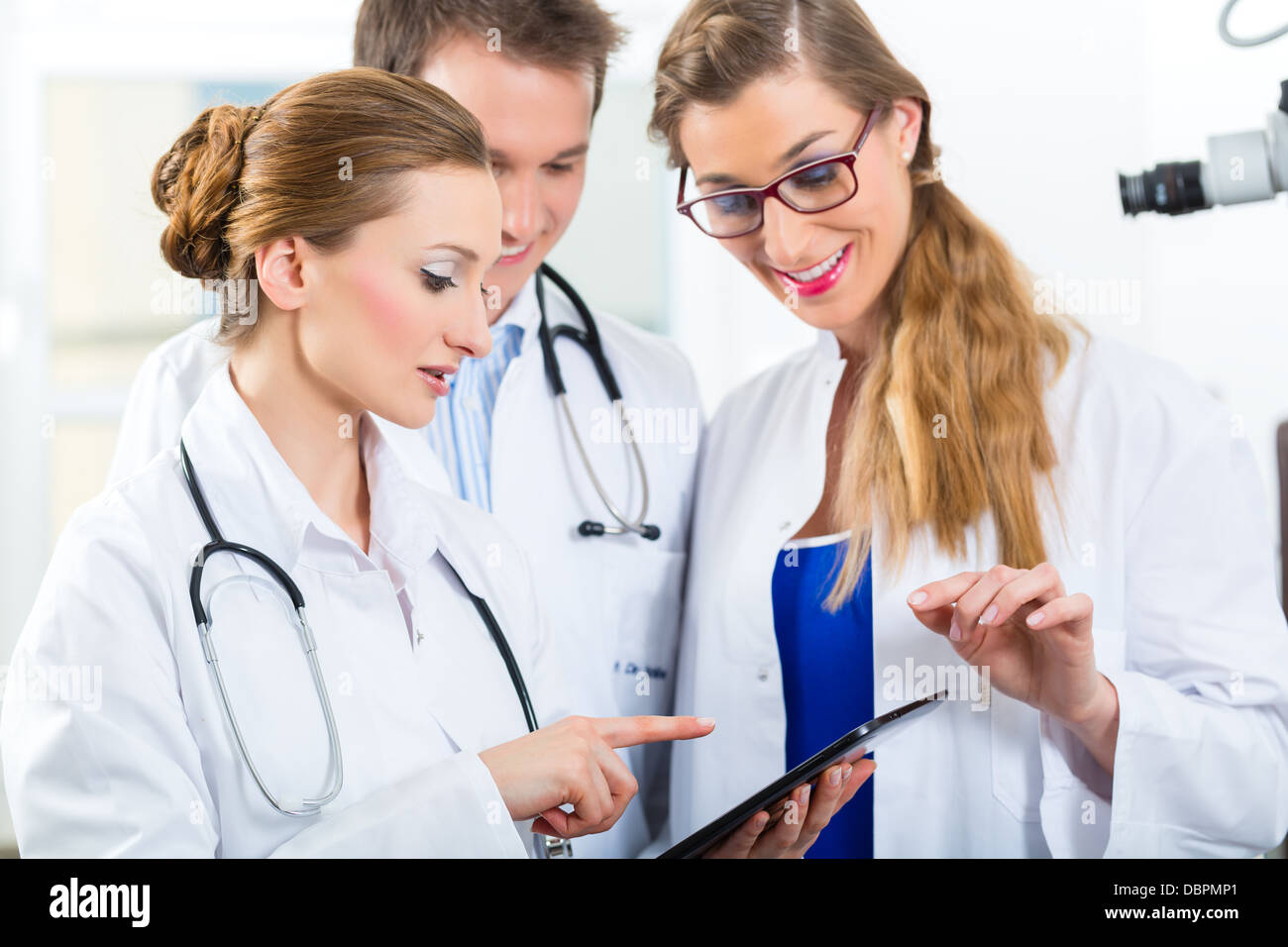 Doctors - male and female - discussing test reports that show on their ...