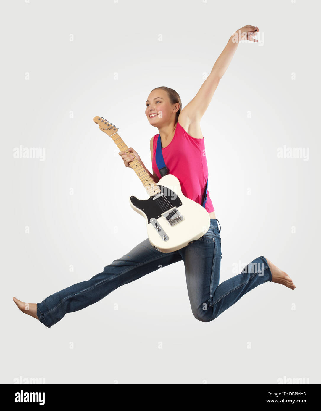 young woman playing on electro guitar and jumping Stock Photo - Alamy