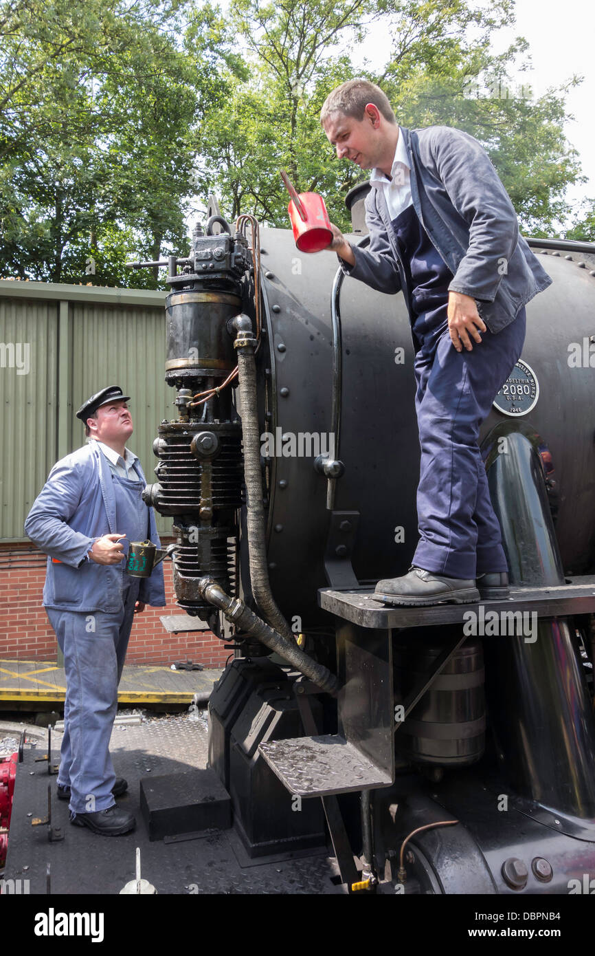 Crew filling lubricators on an American steam locomotive before ...