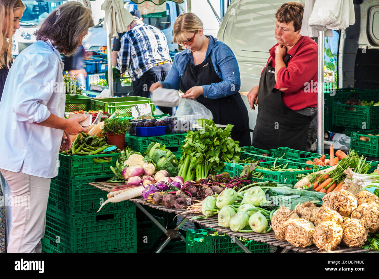 Buying and selling fresh produce from a vegetable stall at the market ...