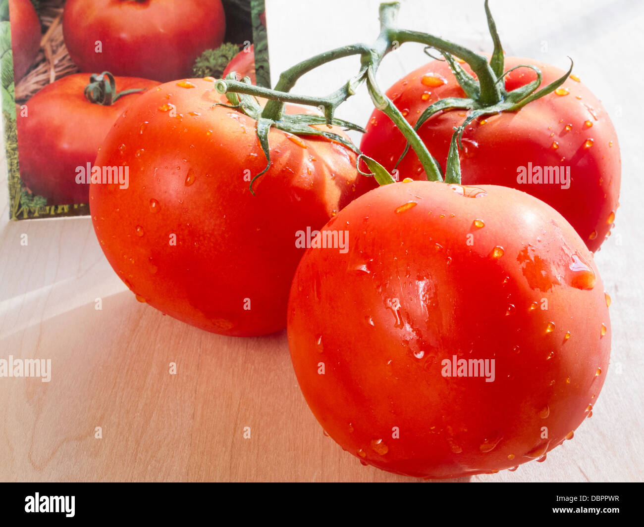 Ripe Tomato and Tomato Seed Packet Still Life Stock Photo - Alamy