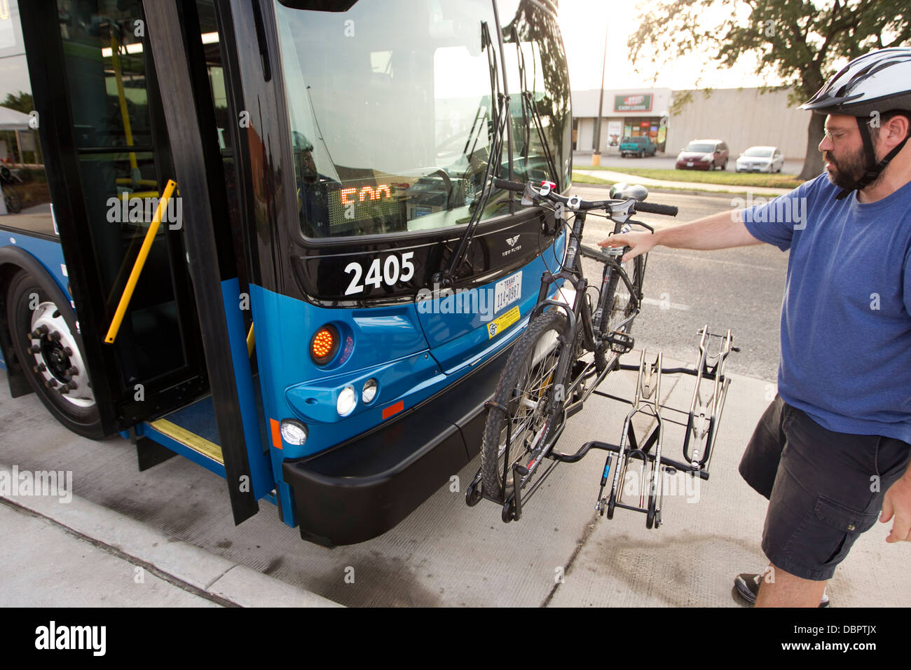 Morning commuters riding bicycles use rack to load their bikes onto a ...
