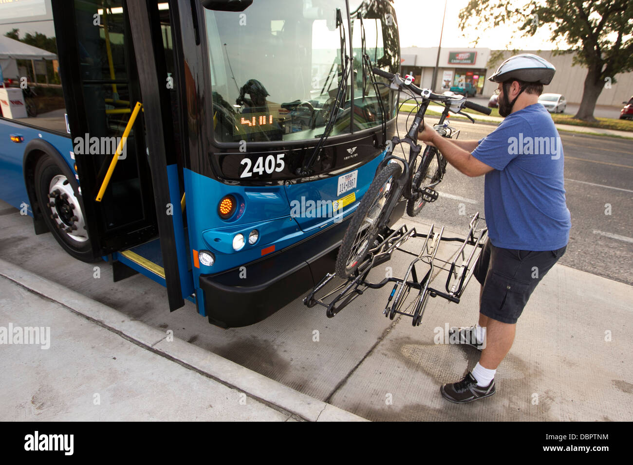 Morning commuters riding bicycles use rack to load their bikes onto a ...
