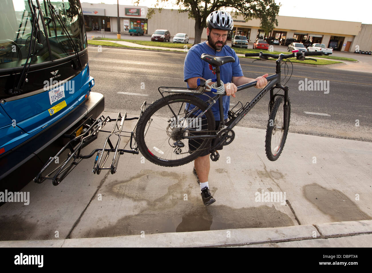 Morning commuters riding bicycles use rack to load their bikes onto a ...