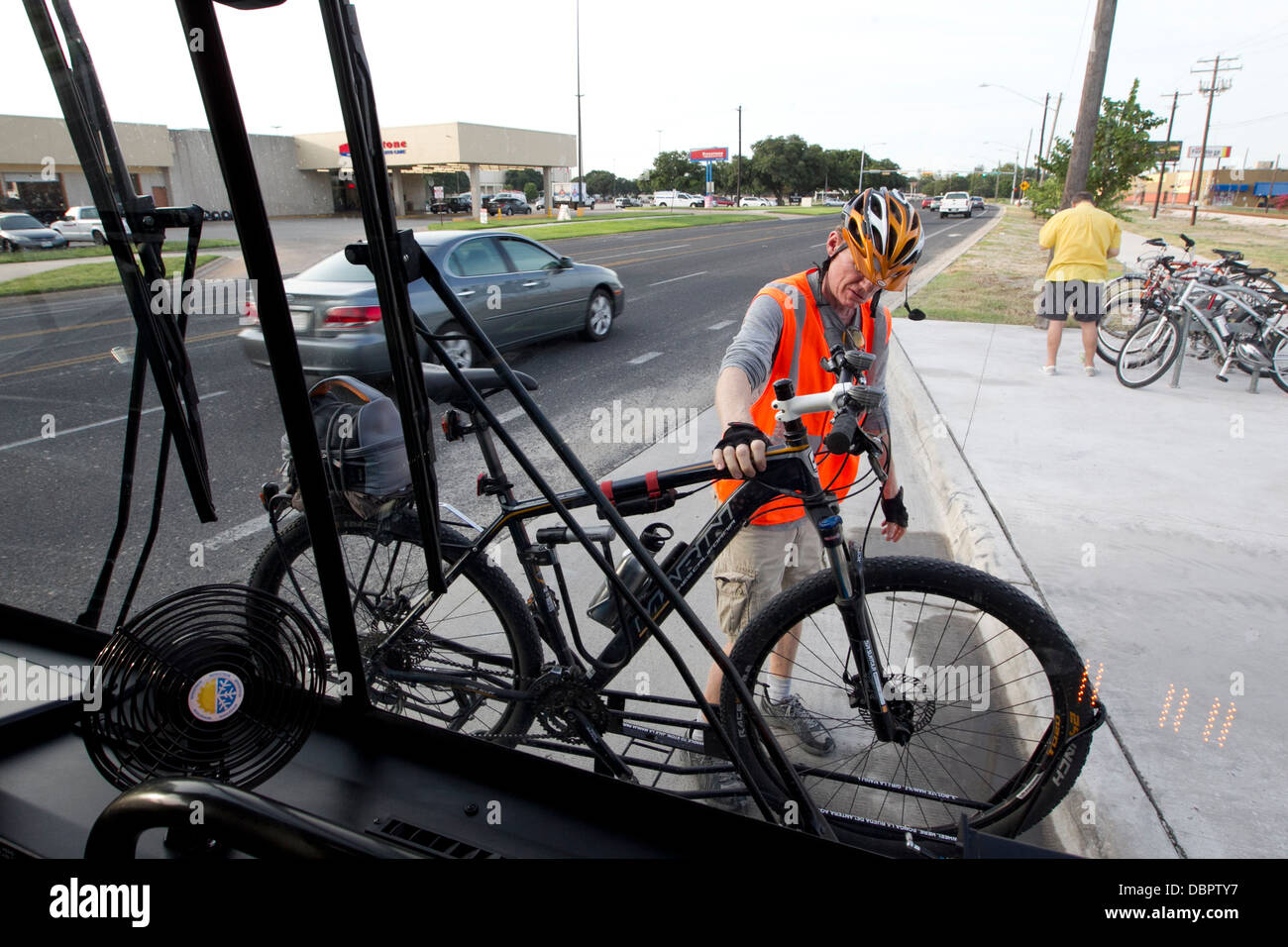 Morning commuters riding bicycles use rack to load their bikes onto a ...